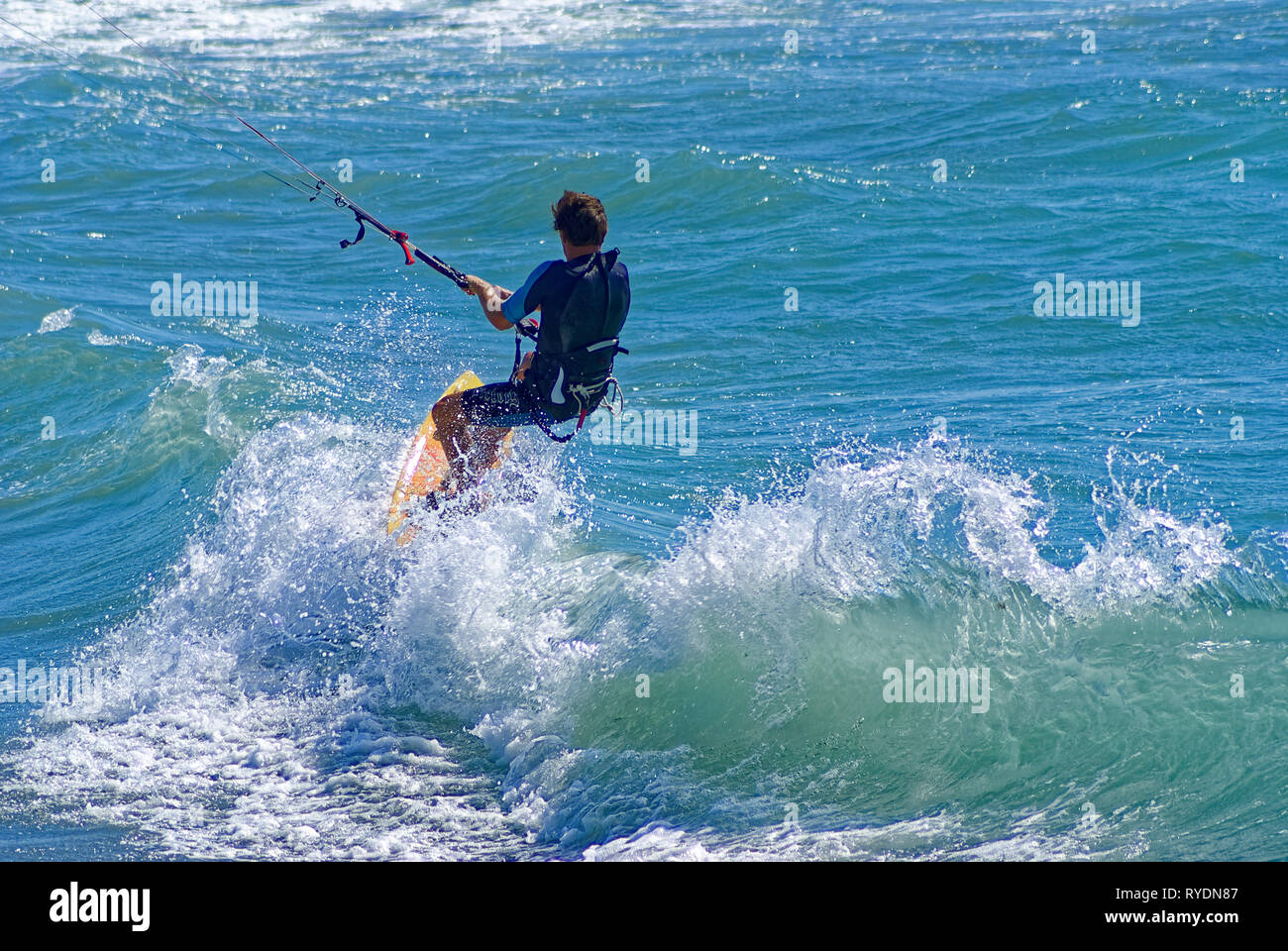 Kite boarder jumping a wave during a windy day in french riviera Stock ...