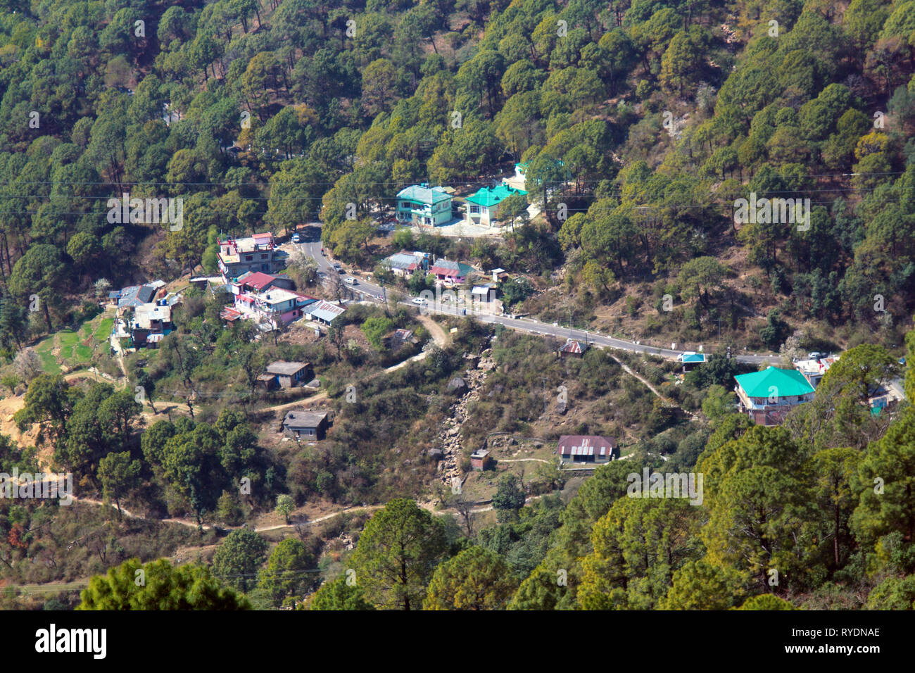 Mountain village in the Pre-Himalayas with asphalt road. India, the ...