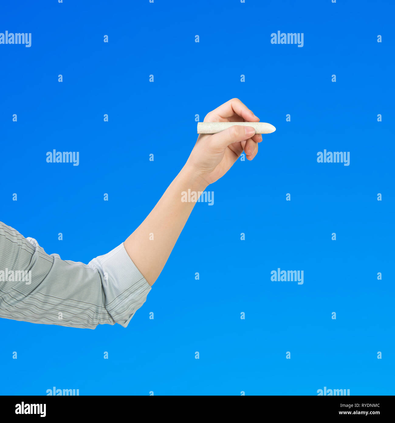 Woman hand holding chalk writing, side view, isolated on blue Stock ...