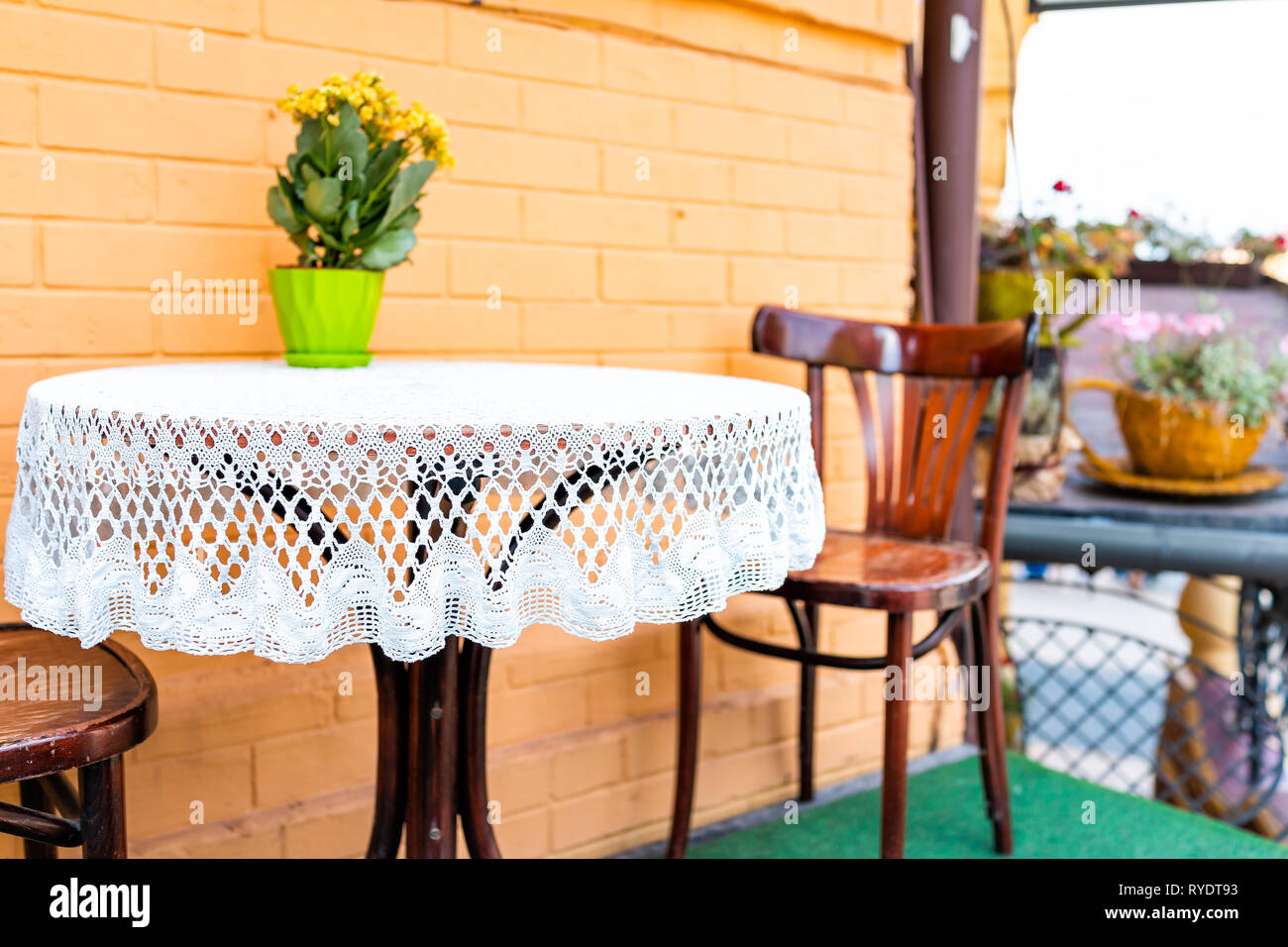 Empty table outside restaurant cafe with chairs on street and yellow ...