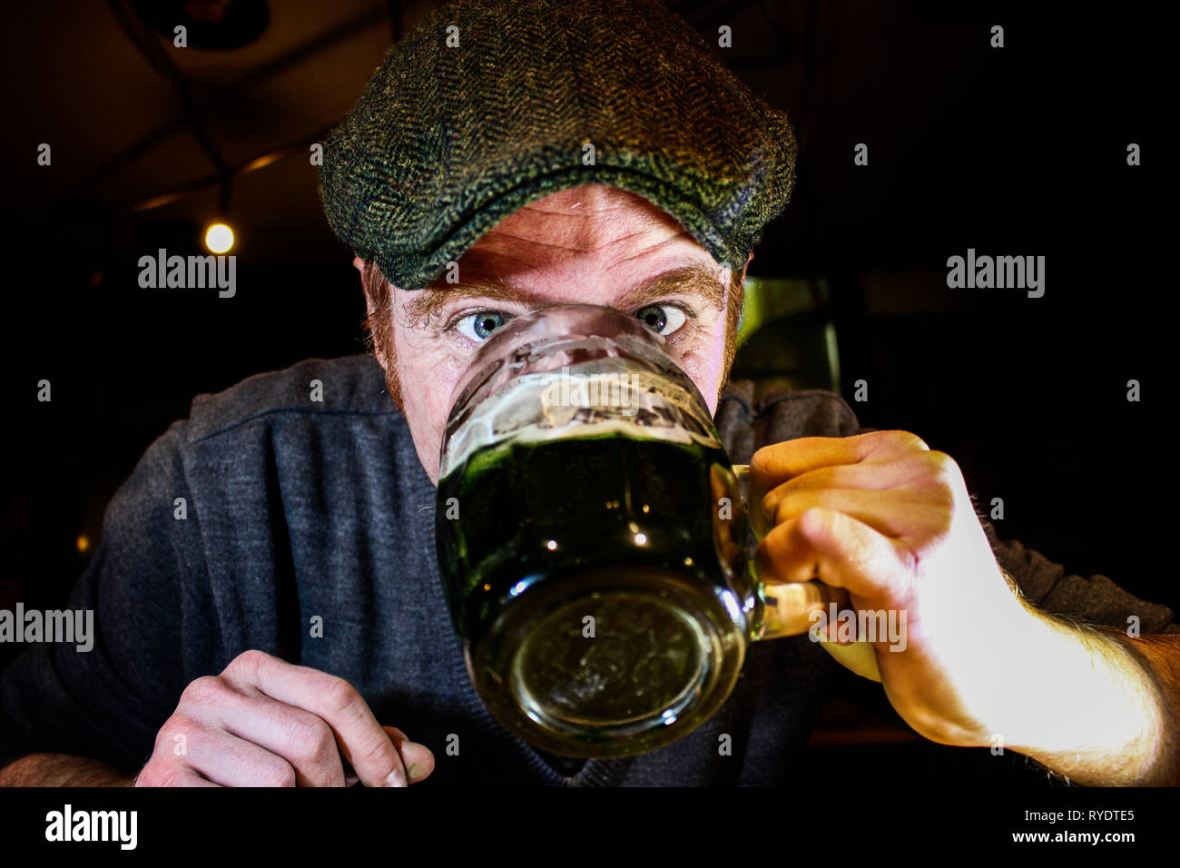 Crazy Irish guy drinks green beer during celebration of St Patrick's ...