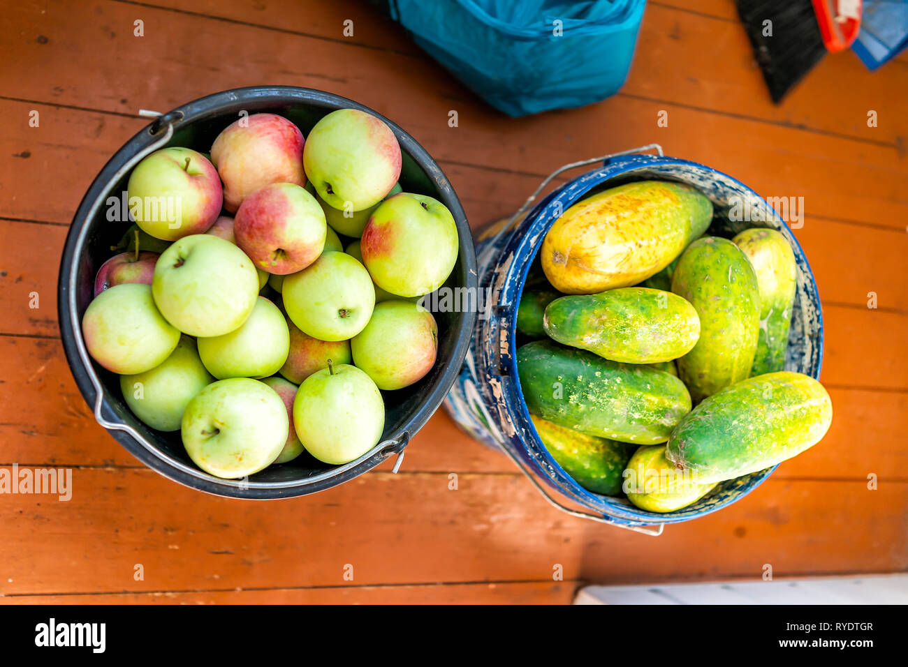 Flat top closeup of two large bucket filled with fresh green red garden ...