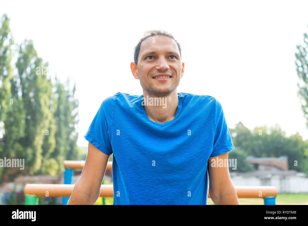 Fit muscular man closeup of face smiling happy looking up doing ...