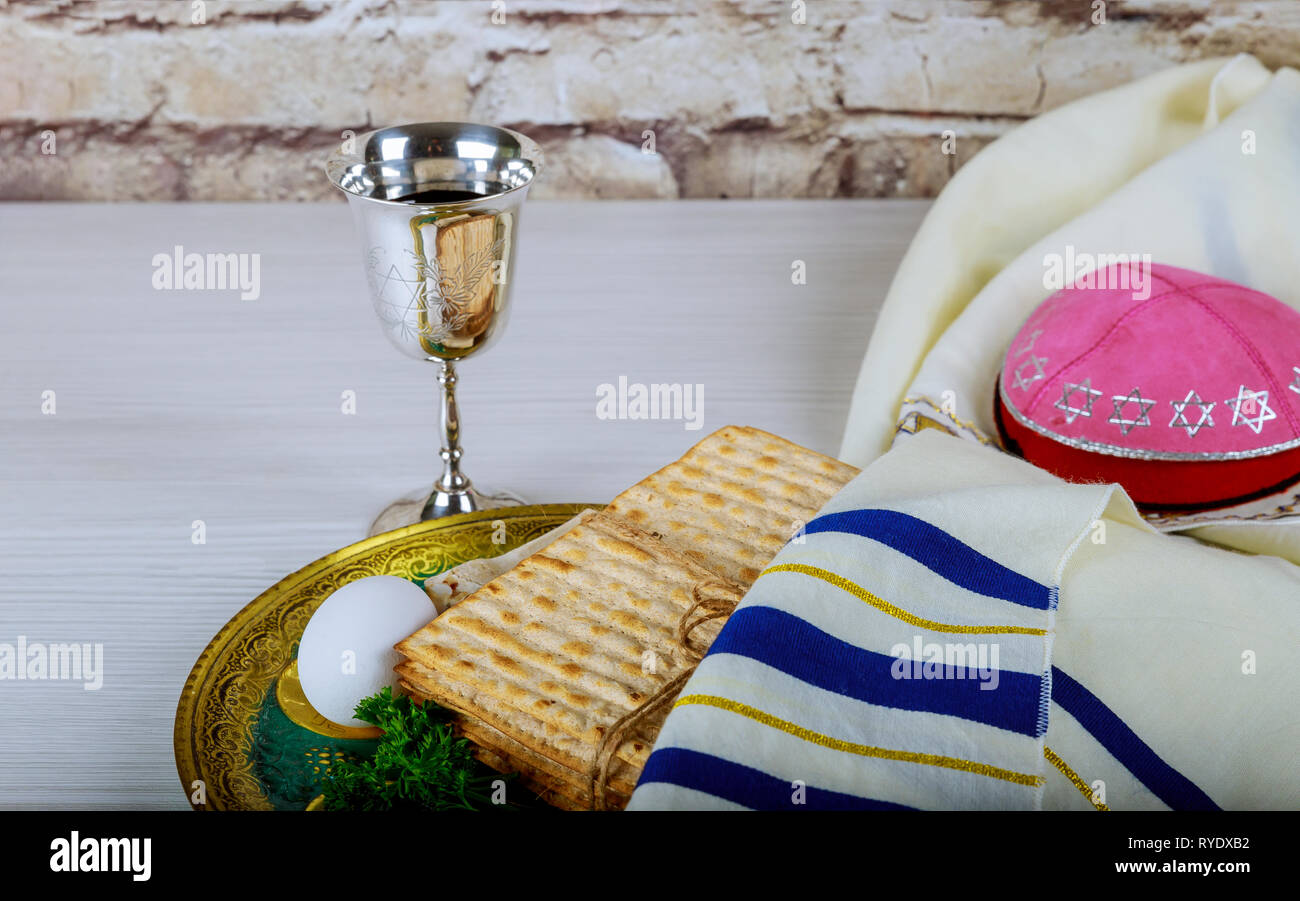 Symbols of Passover glasses wine and matzoh jewish holiday bread over ...