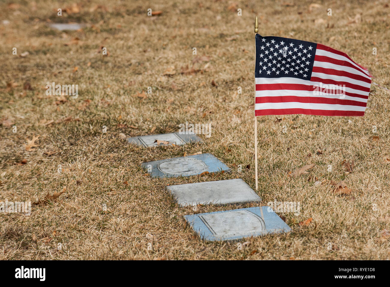 American Flag next to the graves at the cemetery Stock Photo - Alamy