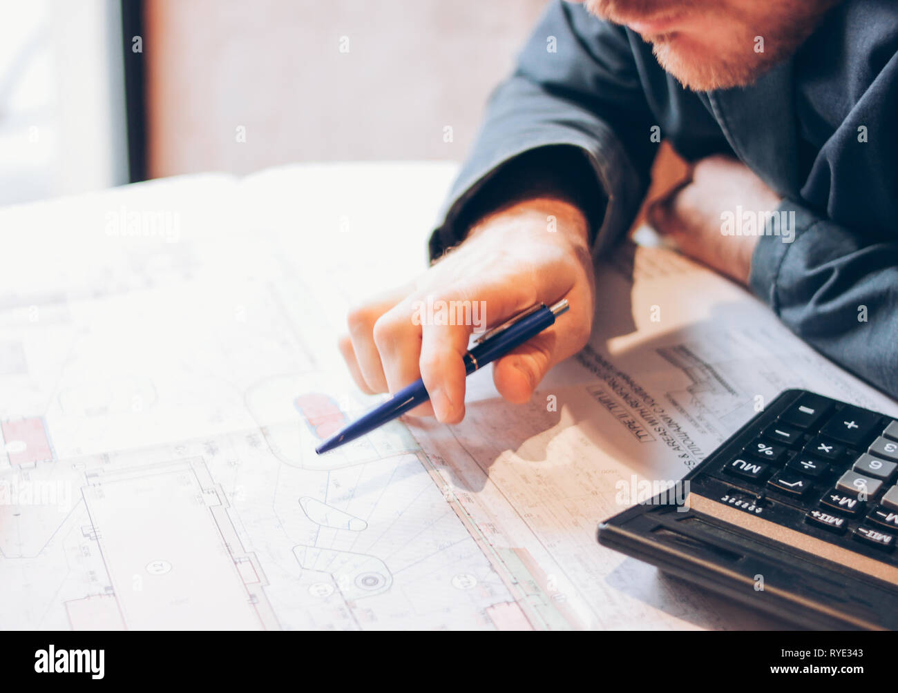 Man engineer designer architect reading drawings at table Stock Photo ...