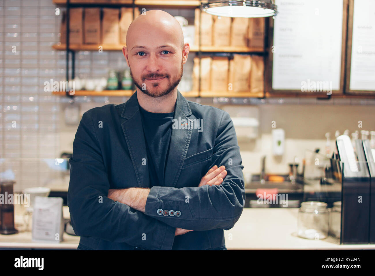 Portrait Of Attractive Adult Successful Bald Bearded Man In Suit On