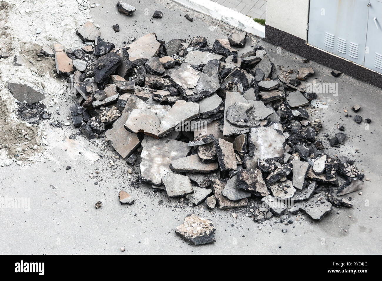 Pile of crushed broken asphalt. City road renewal. Heap of broken road ...