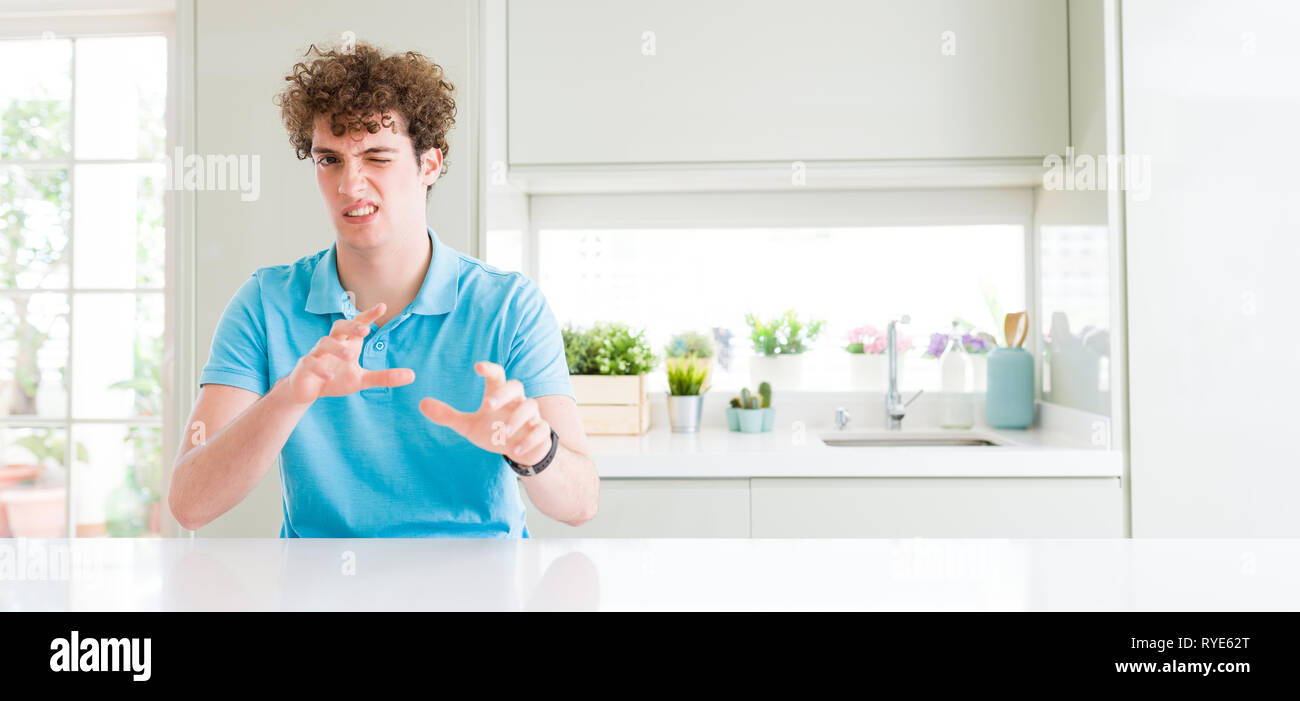 Wide shot of young handsome man at home disgusted expression ...