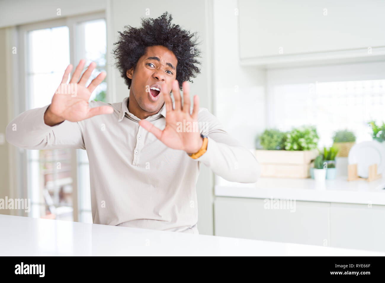 African American man at home afraid and terrified with fear expression ...