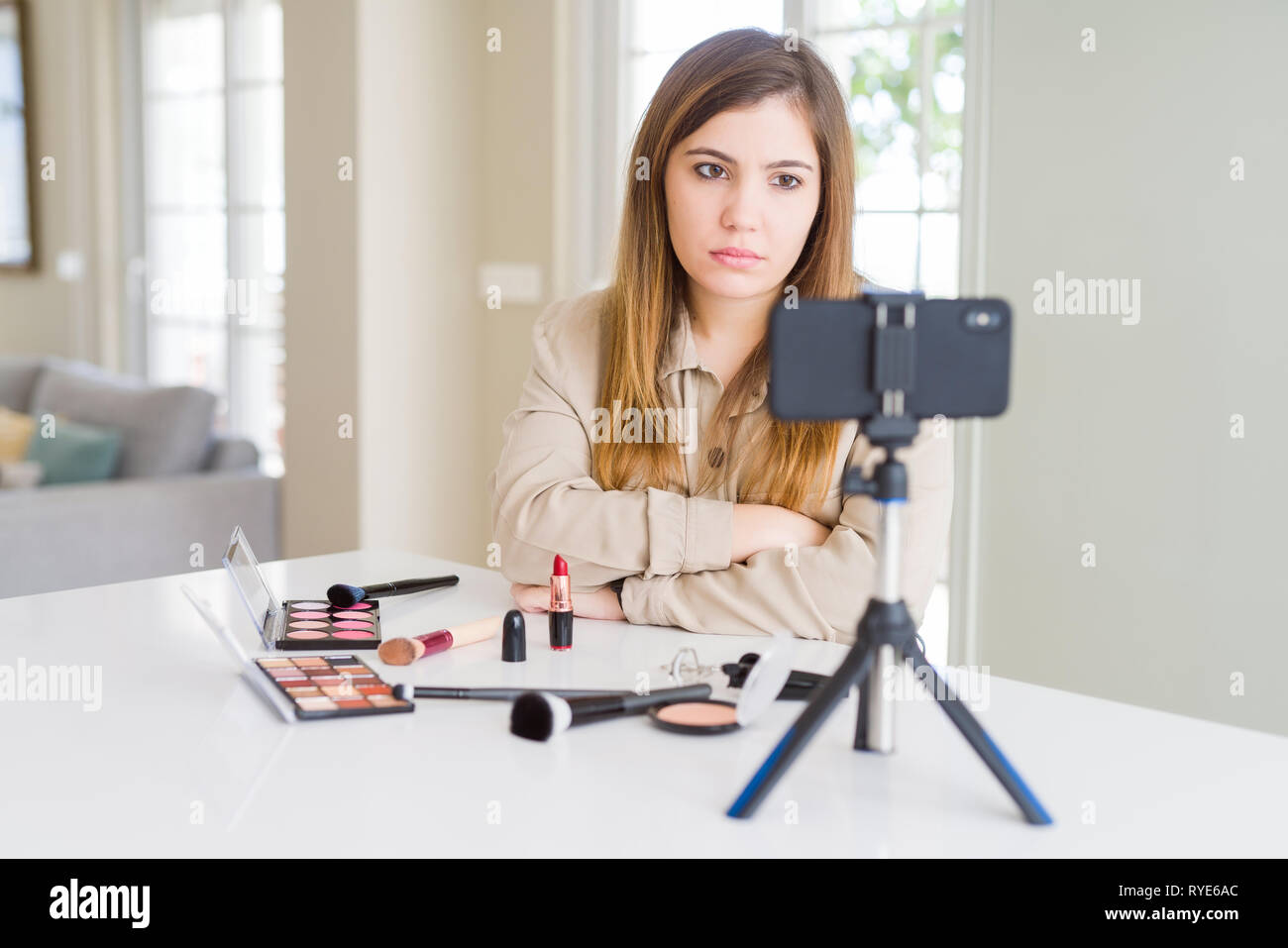 Beautiful young influencer woman recording make up video tutorial ...