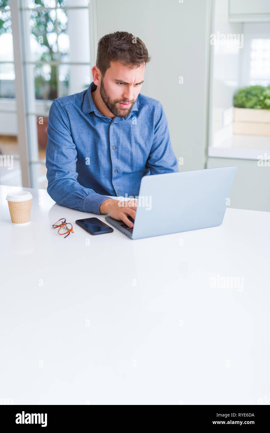Handsome business man working using computer laptop and smiling Stock ...