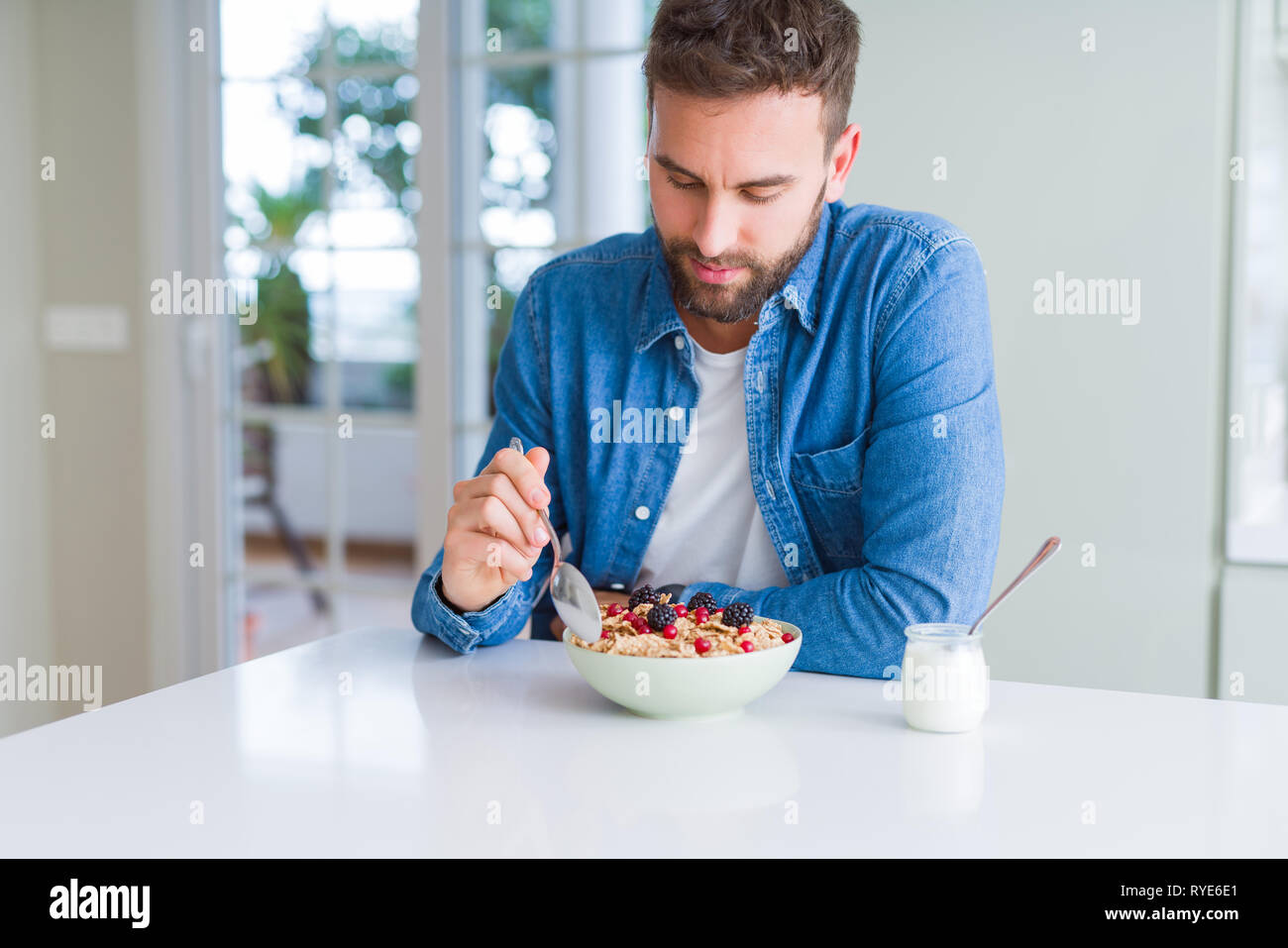 Handsome young man eating cereal hi-res stock photography and images ...