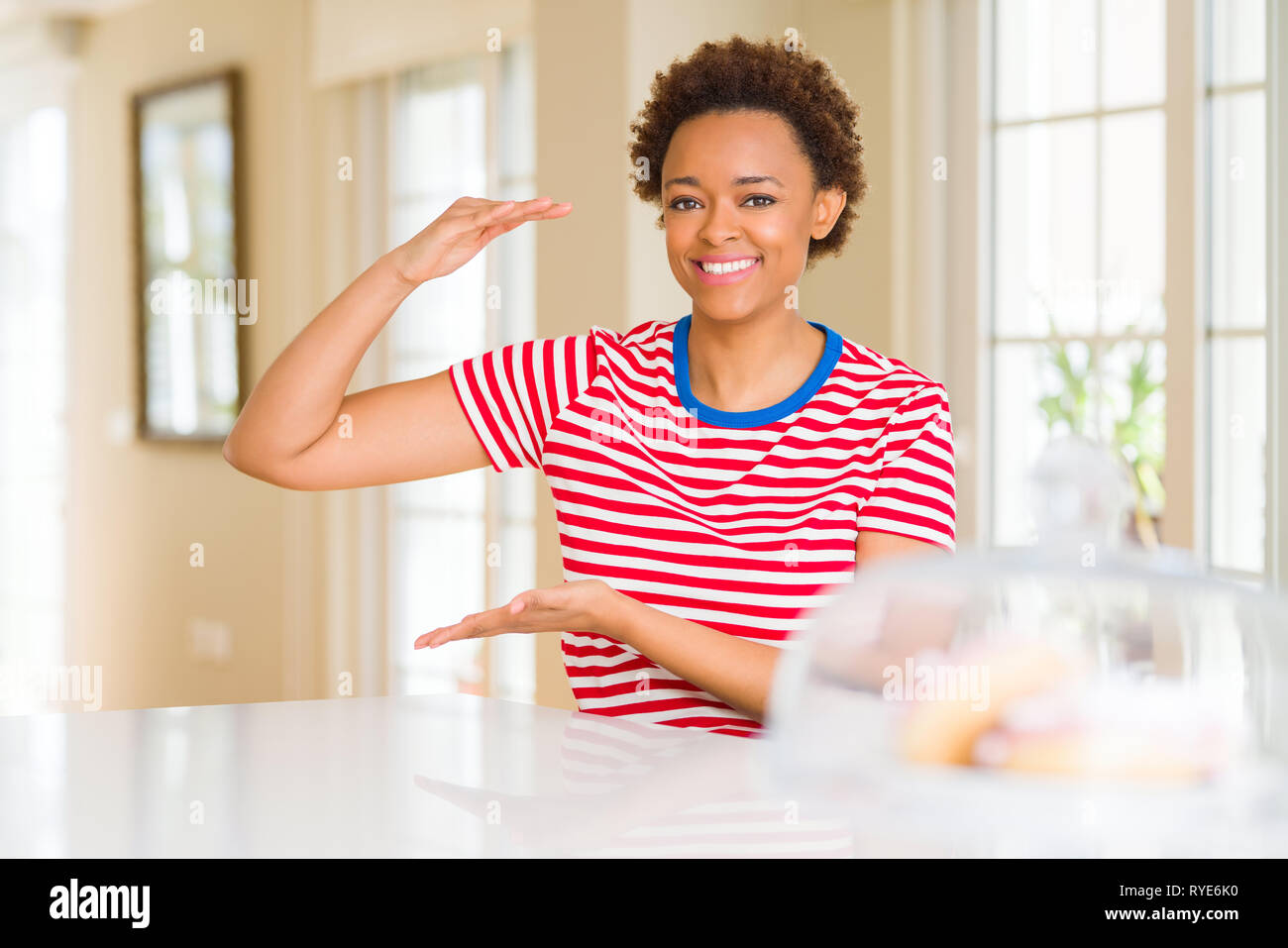 Young beautiful african american woman at home gesturing with hands ...