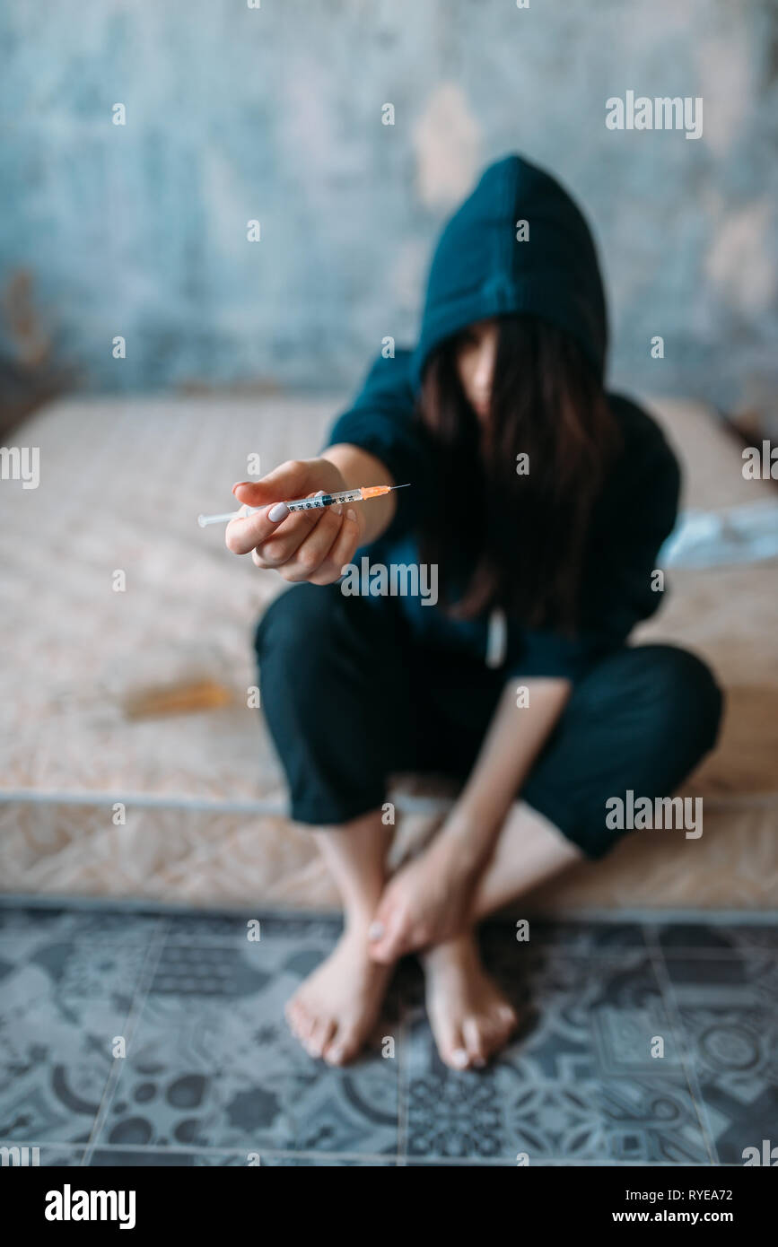 Drug addict with a syringe doing an injection dose Stock Photo - Alamy