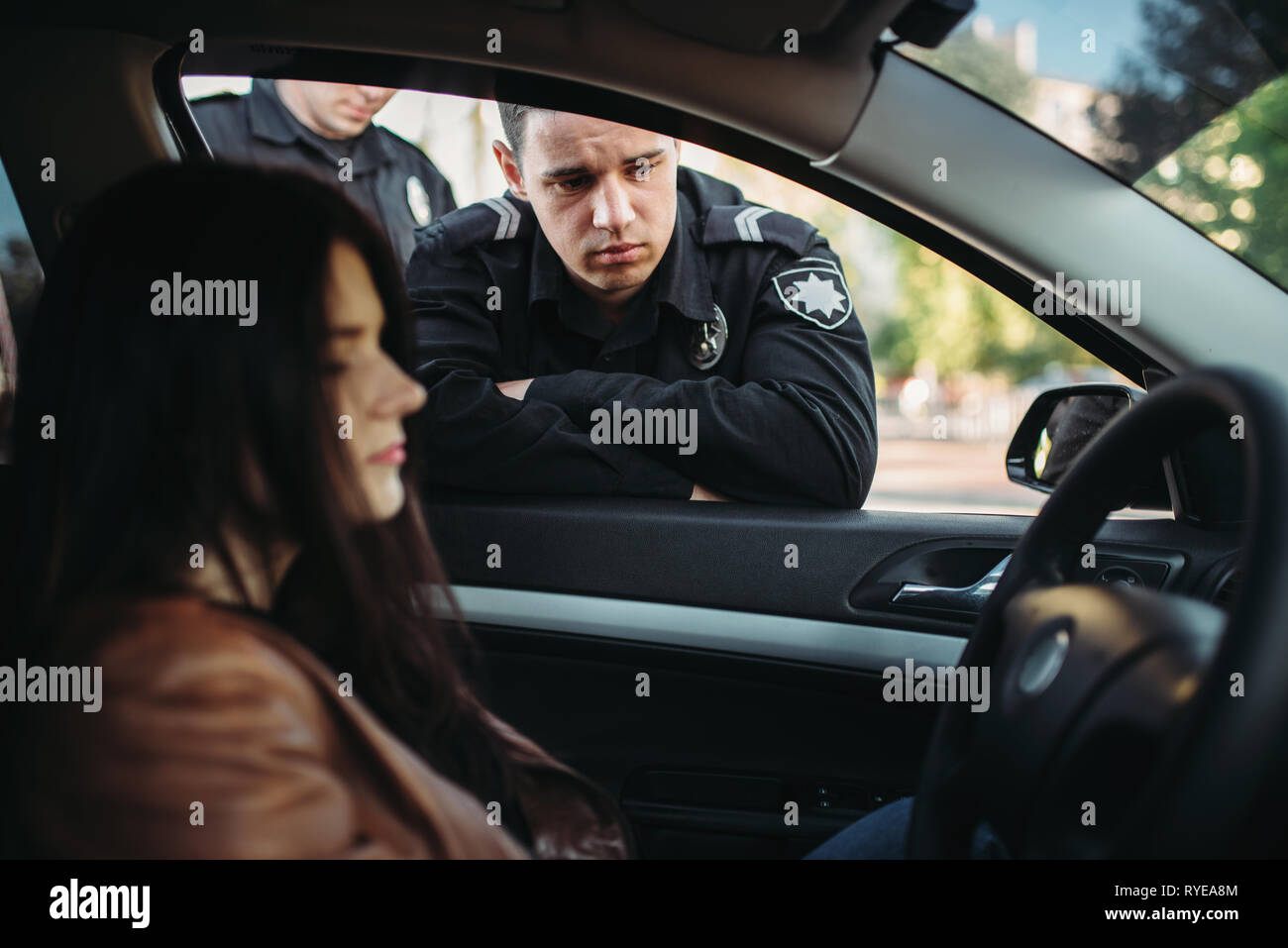 Police officers in uniform check female driver Stock Photo - Alamy