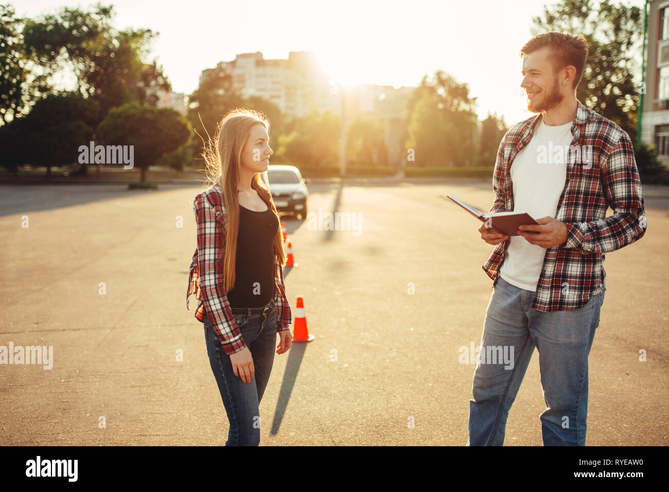 Male instructor and female student, driving school Stock Photo - Alamy