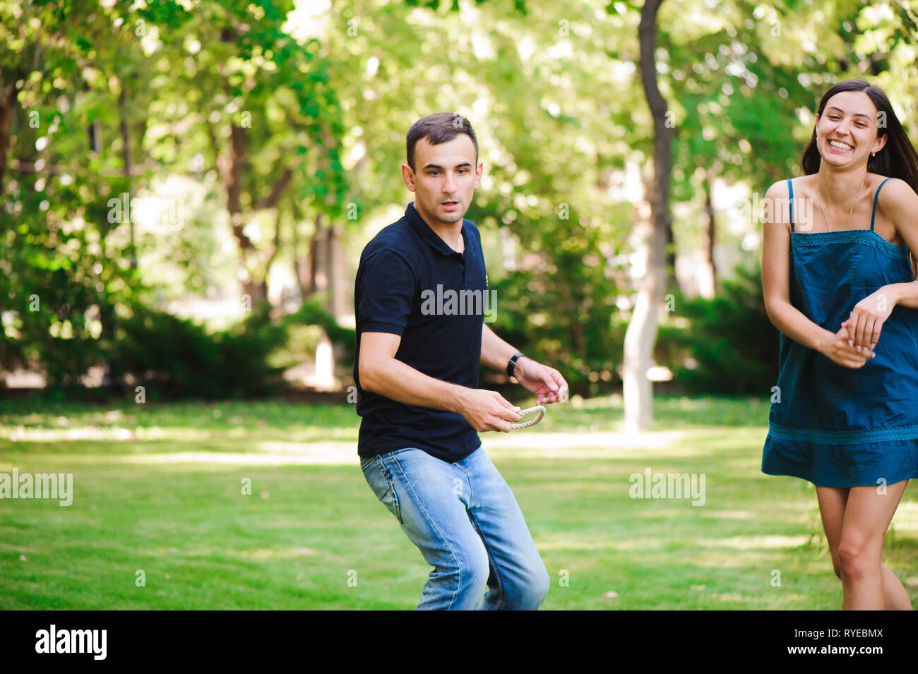 Guy and girl compete in the ring toss Stock Photo - Alamy