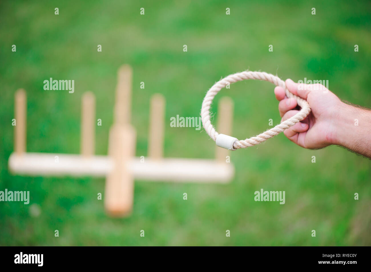 Boy playing a game throwing rings outdoors in summer park Stock Photo ...