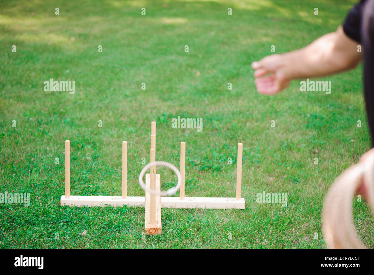 Boy playing a game throwing rings outdoors in summer park Stock Photo ...
