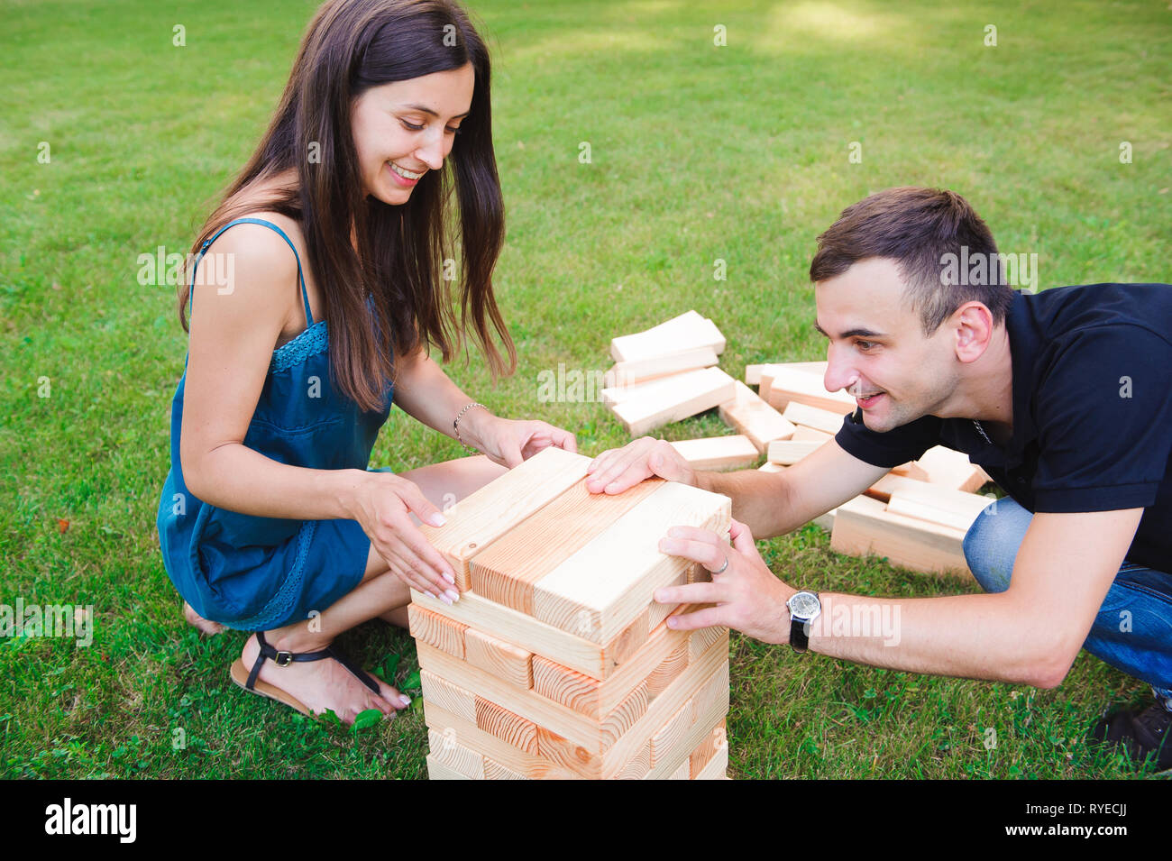 Group game of physical skill with big blocks Stock Photo - Alamy