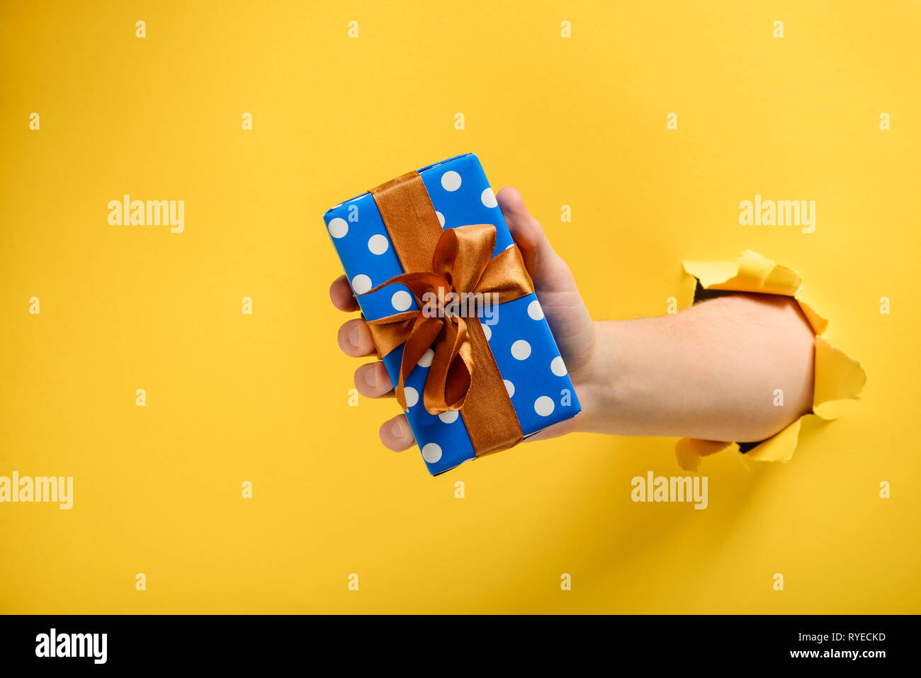 Hand giving a gift box Stock Photo - Alamy