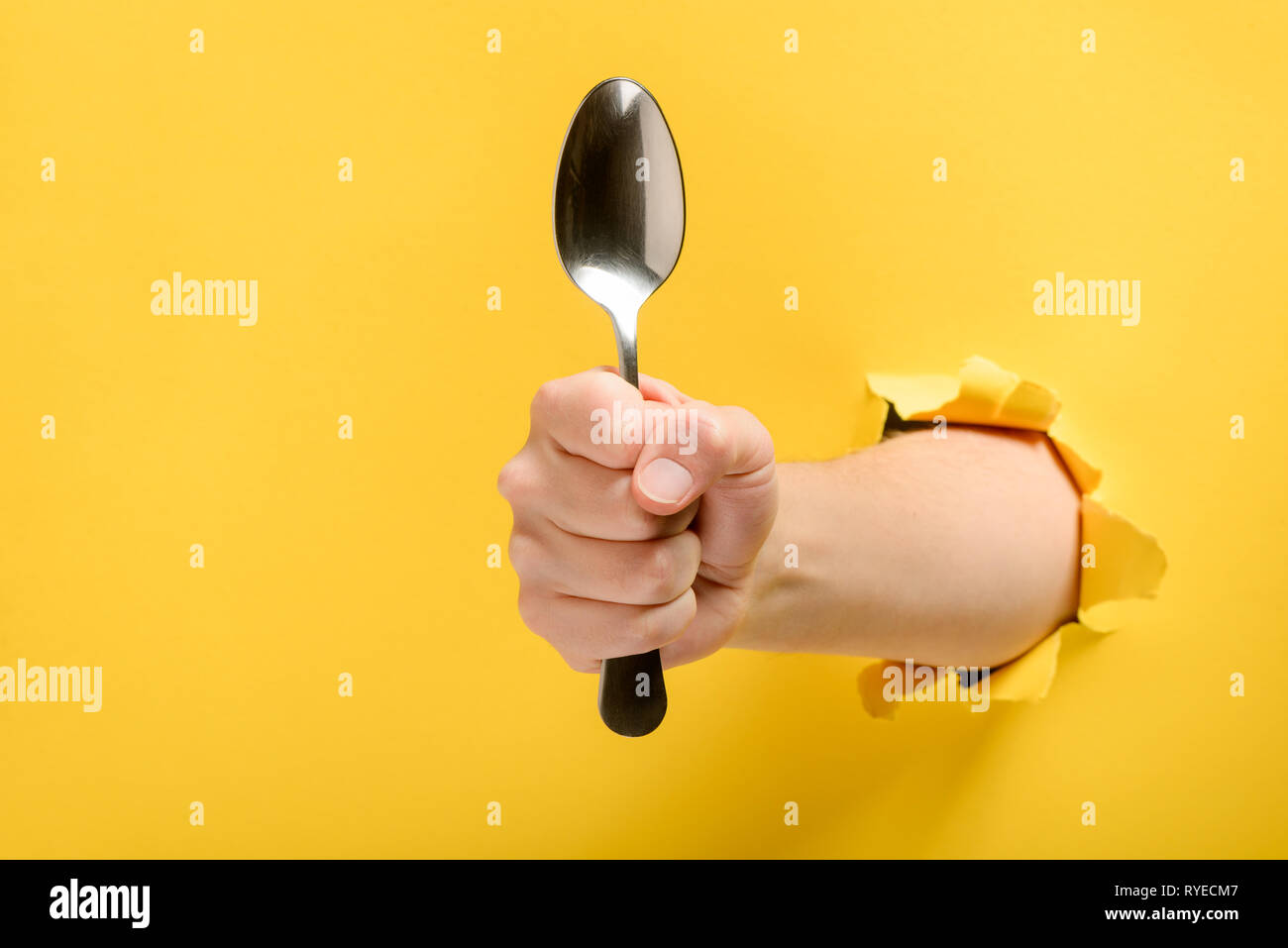 Hand giving a spoon Stock Photo - Alamy
