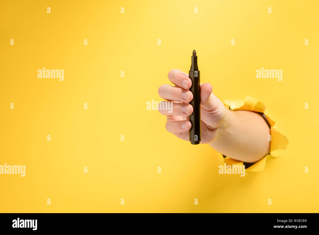 Hand giving a permanent marker Stock Photo - Alamy