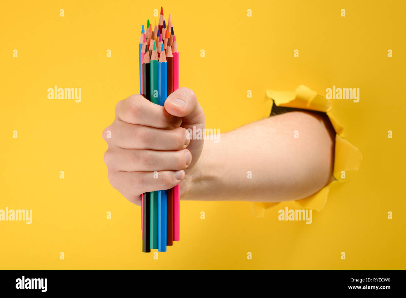 Hand giving colored pencils Stock Photo - Alamy