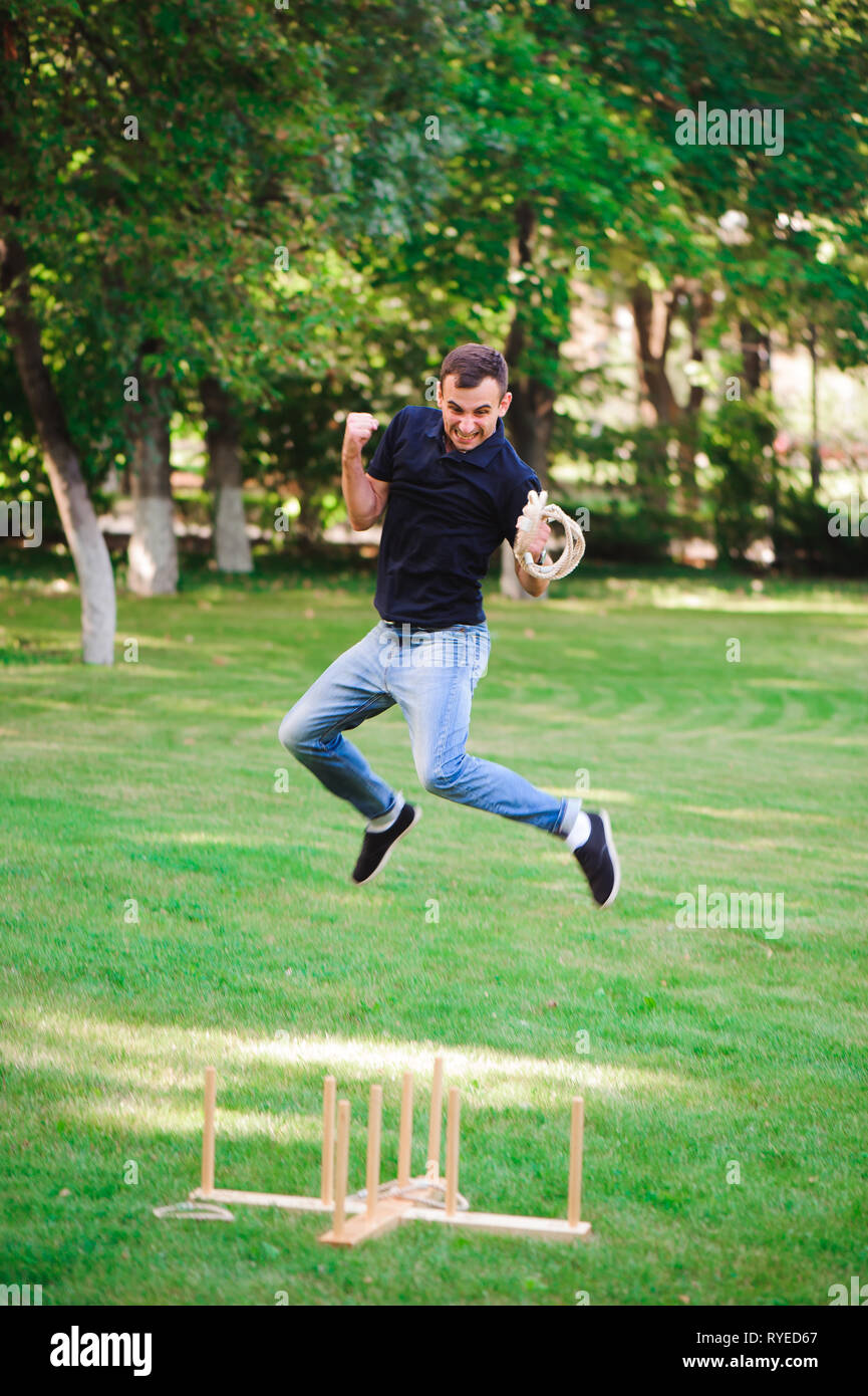 Boy playing a game throwing rings outdoors in summer park Stock Photo ...