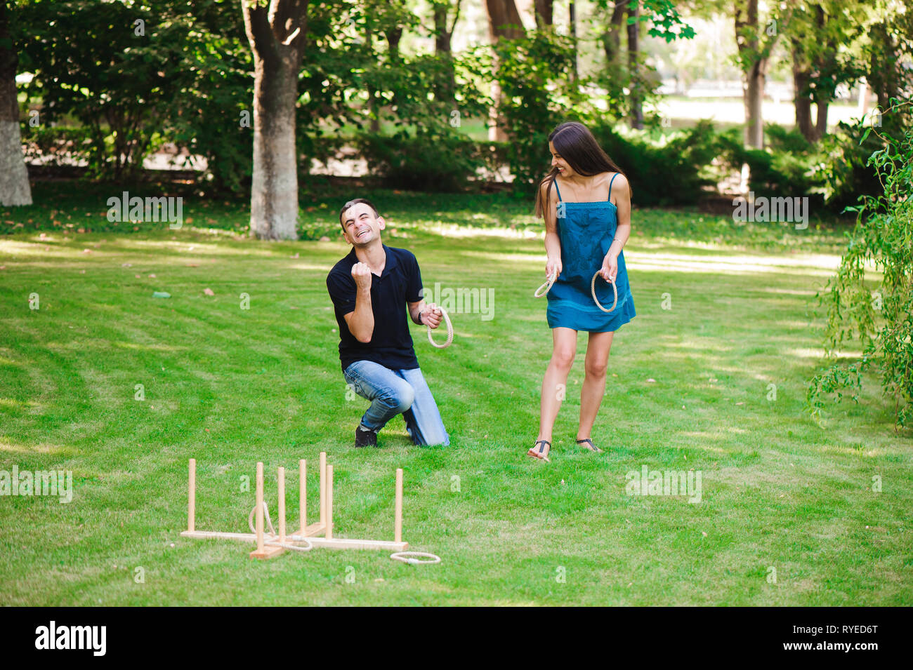 Guy and girl compete in the ring toss Stock Photo - Alamy