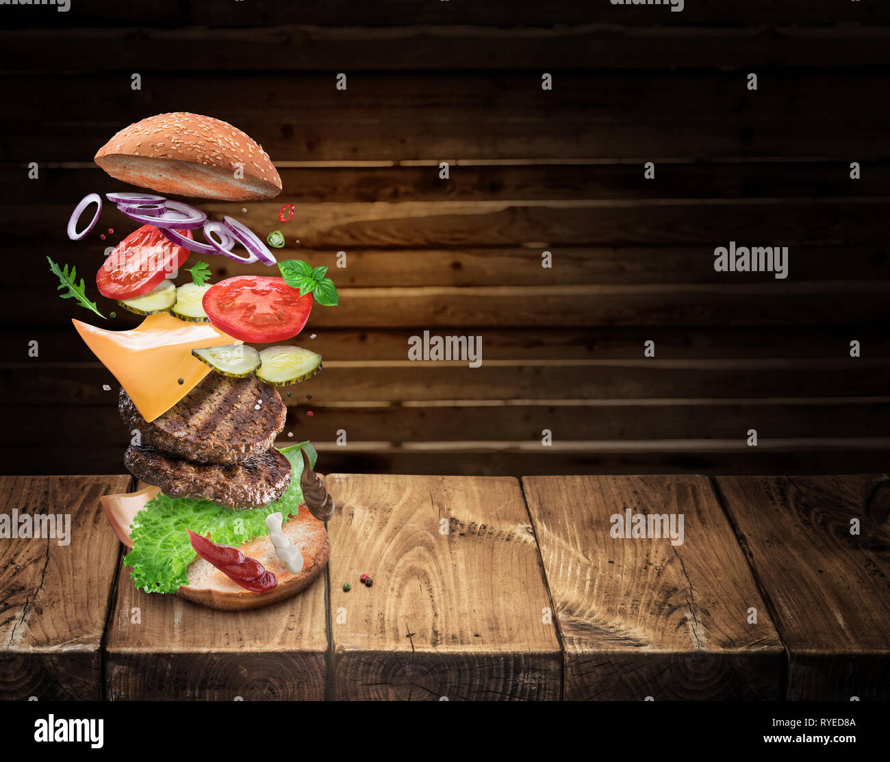 Hamburger ingredients falling down one by one to create a perfect meal ...