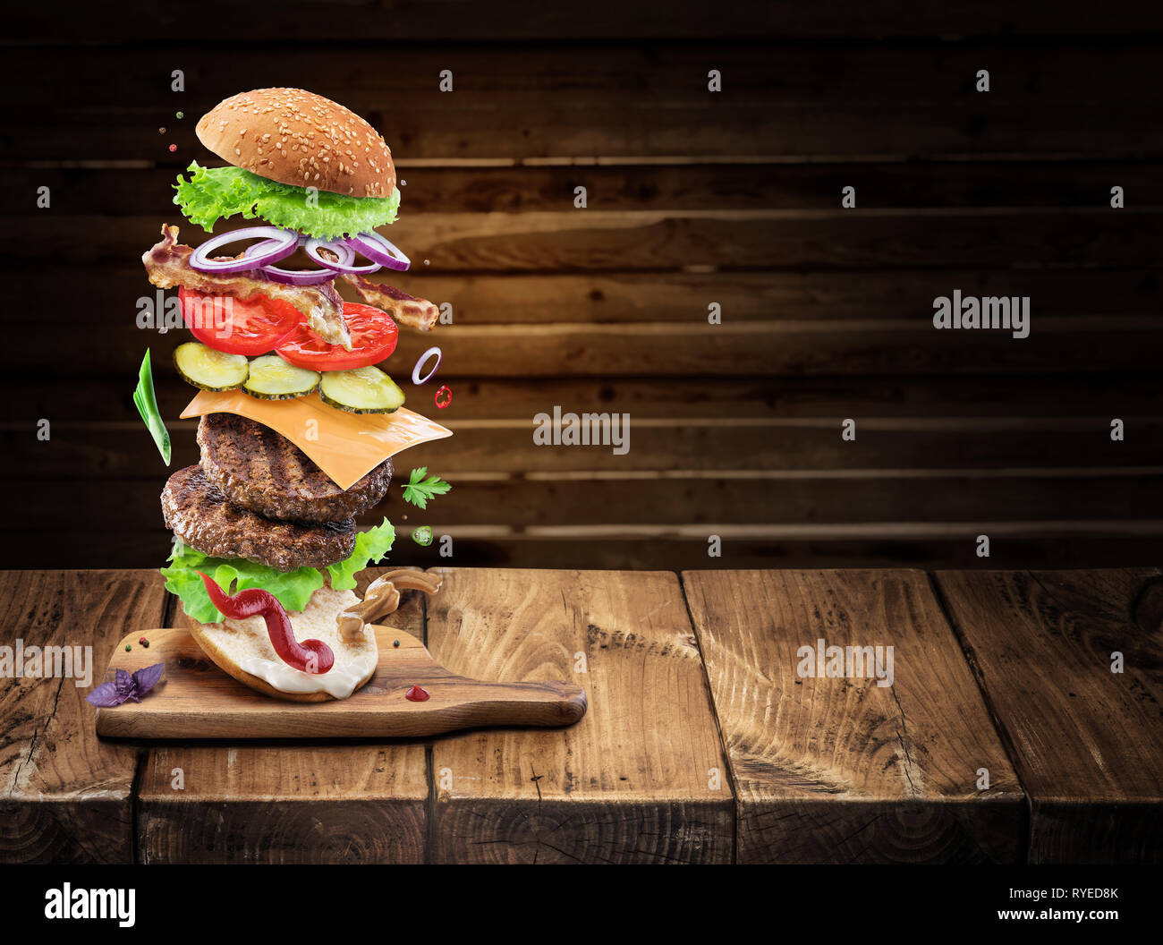 Hamburger ingredients falling down one by one to create a perfect meal ...