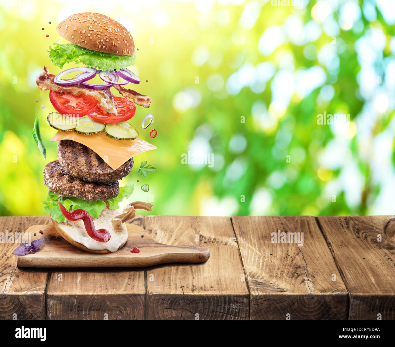 Hamburger ingredients falling down one by one to create a perfect meal ...