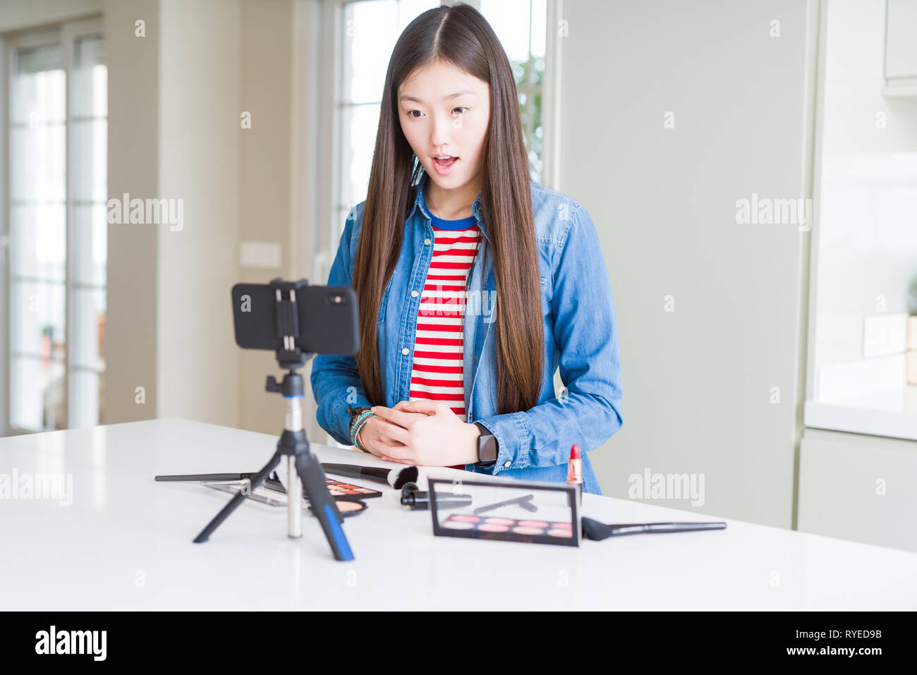 Beautiful Asian influencer woman recording make up tutorial using ...