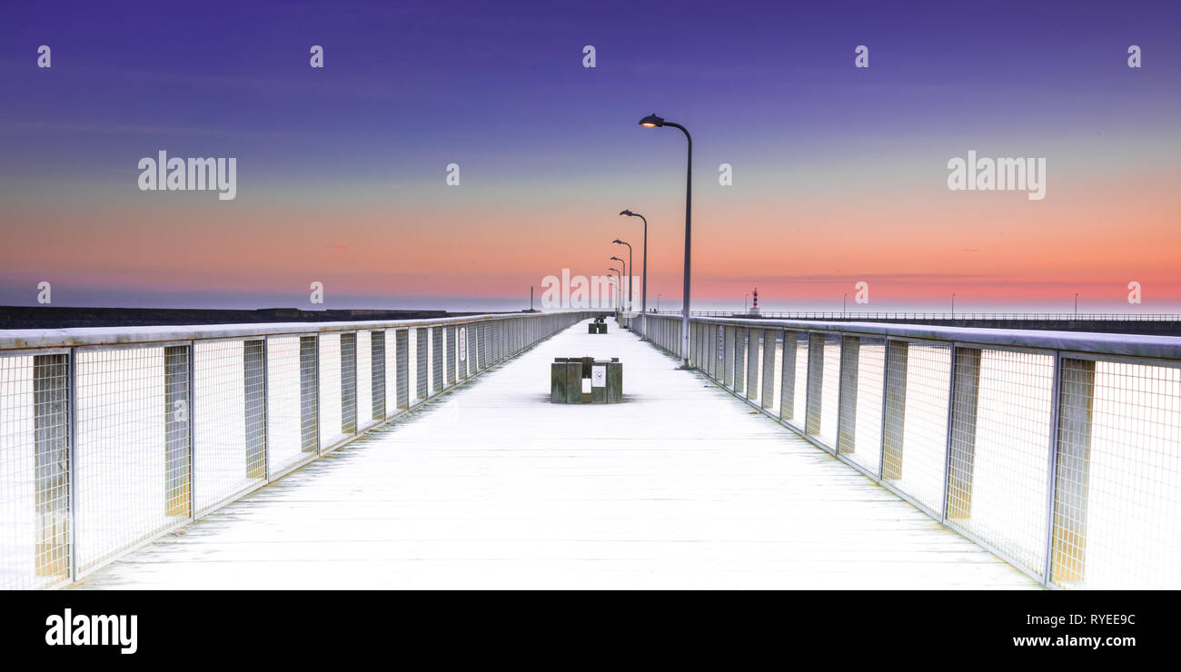 Wooden pier and colourful sunset sky in Amble, Northumberland Stock ...