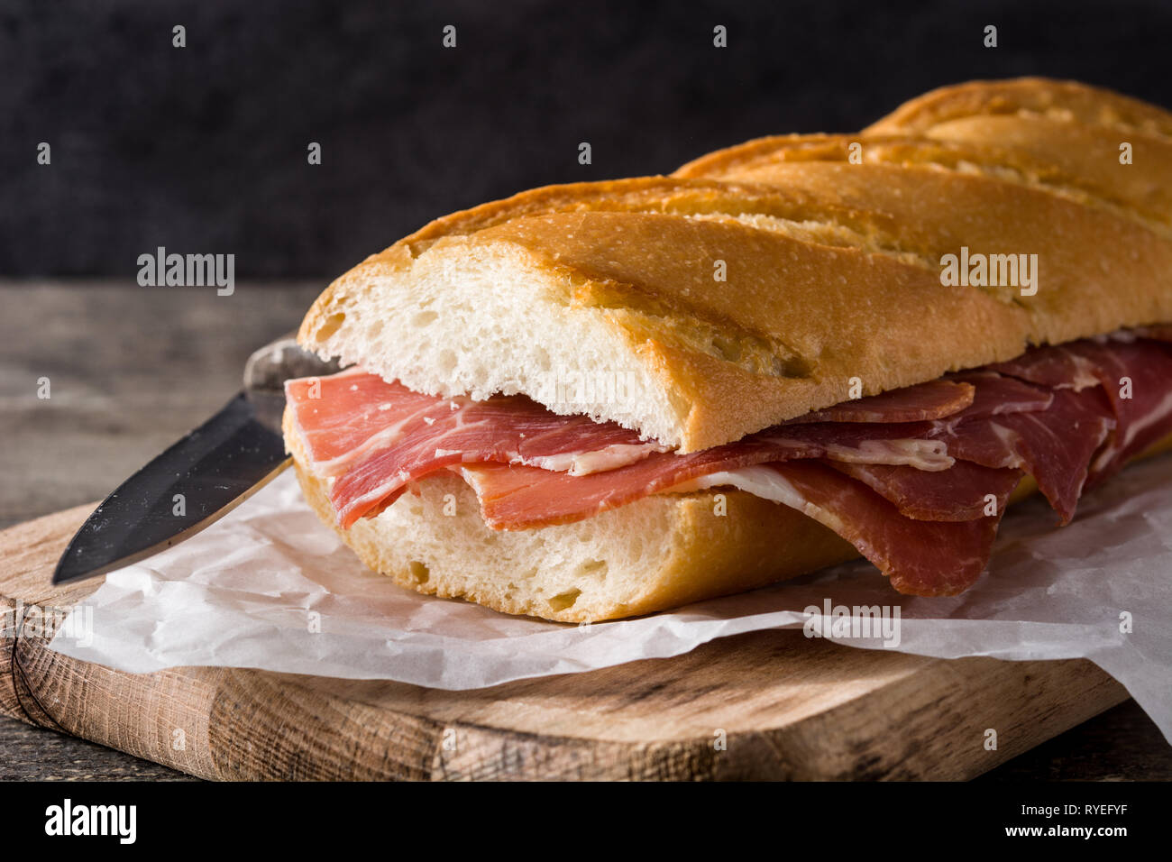Spanish serrano ham sandwich on wooden table Stock Photo - Alamy