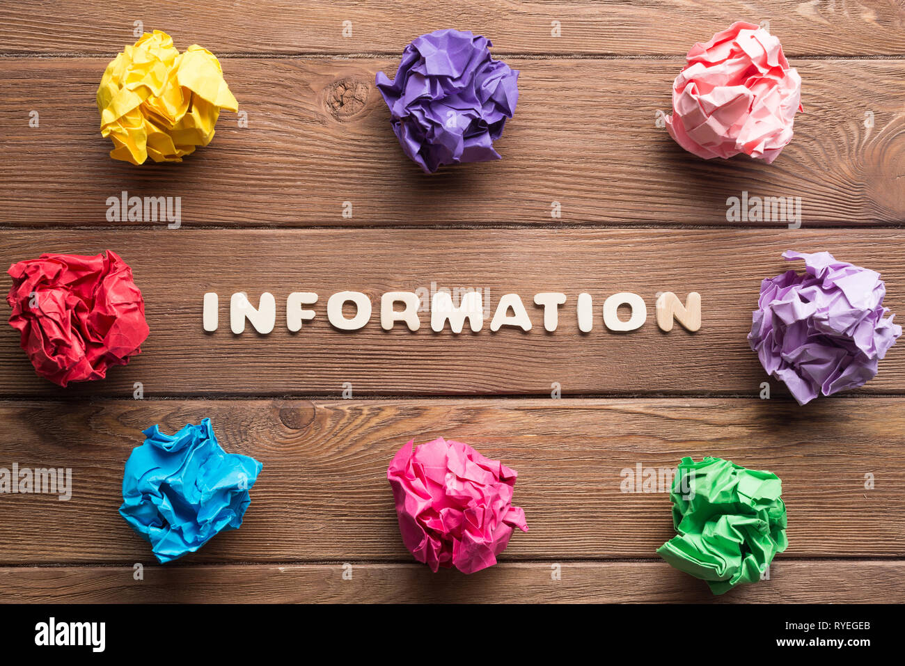 colorful crampled paper ball placed in circle on wooden table Stock ...