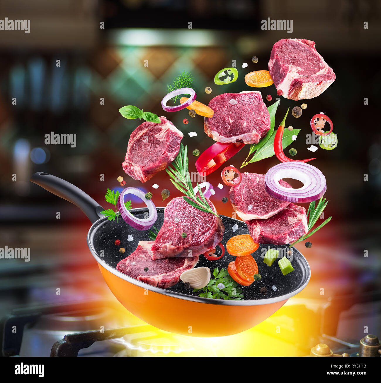 Flying meat steaks and spices falling into a frying pan. Flying motion ...