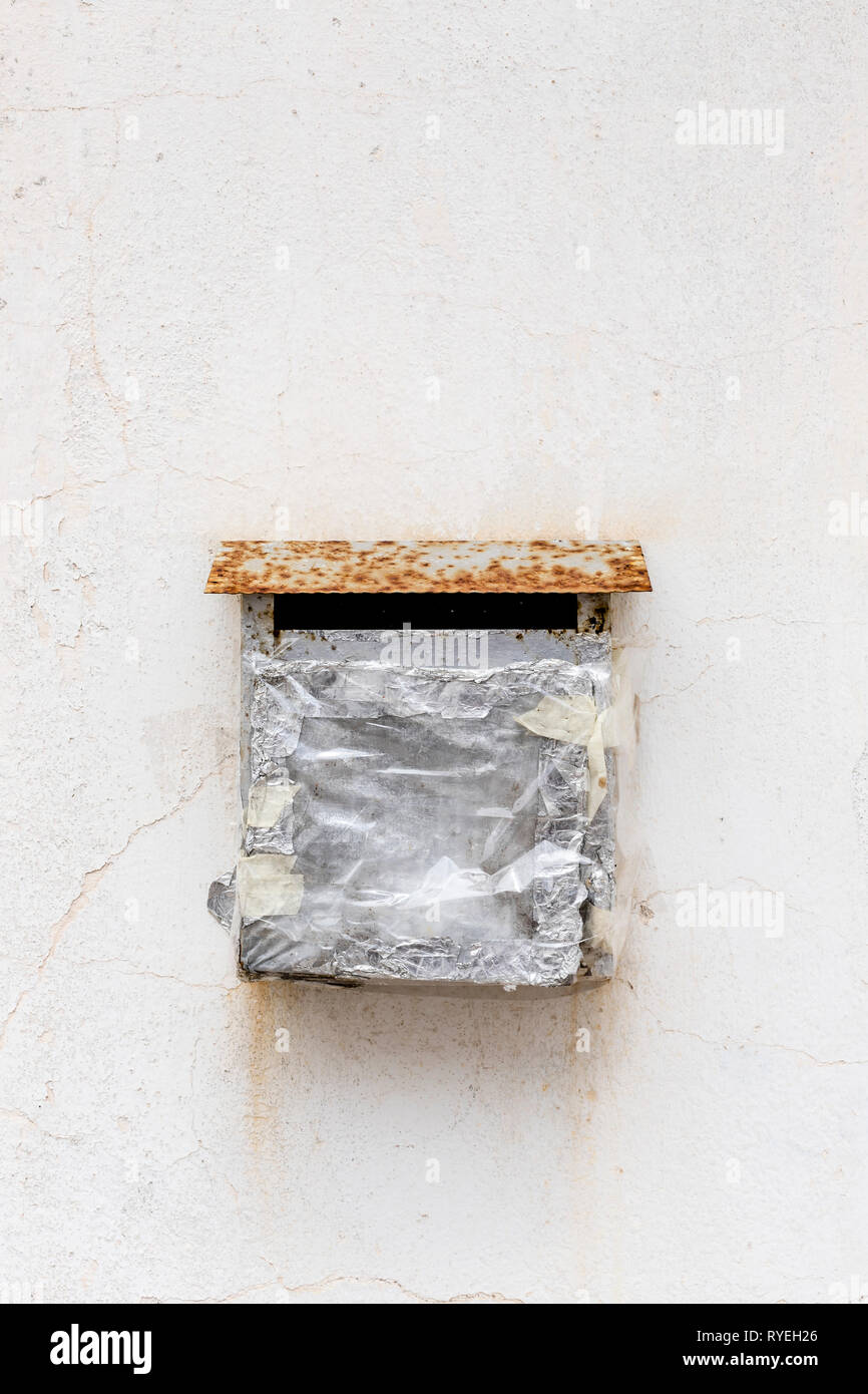 Weathered mailbox on a wall Stock Photo - Alamy