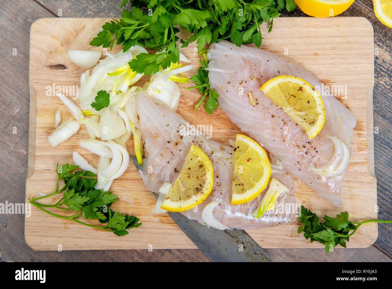 Fresh fish, a raw cod fillets with addition of herbs and lemon Stock ...