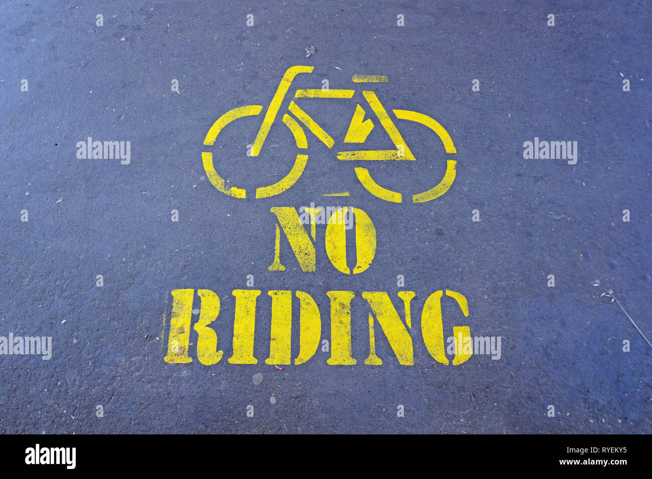 No riding warning sign airbrushed onto the road as a stencil template ...