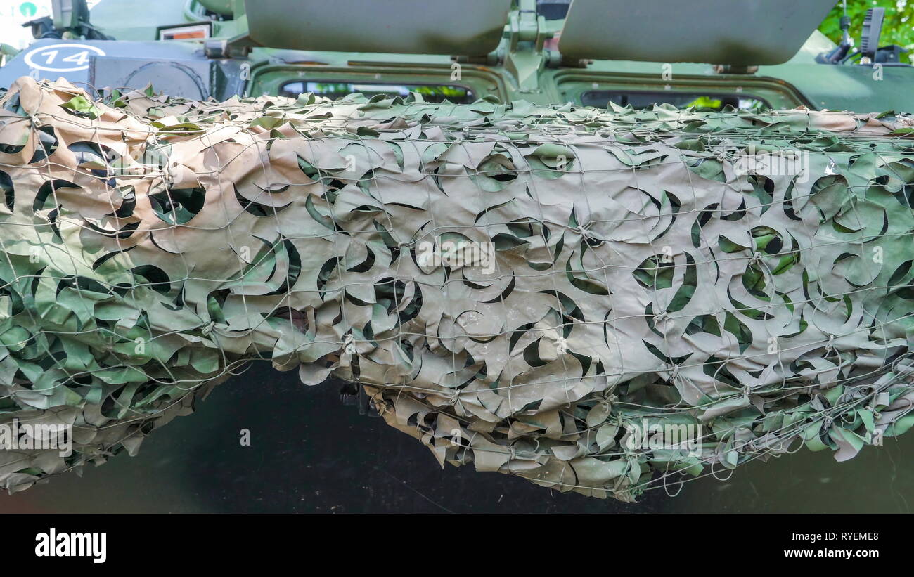 The brown camouflage cover of the military tank used for military ...