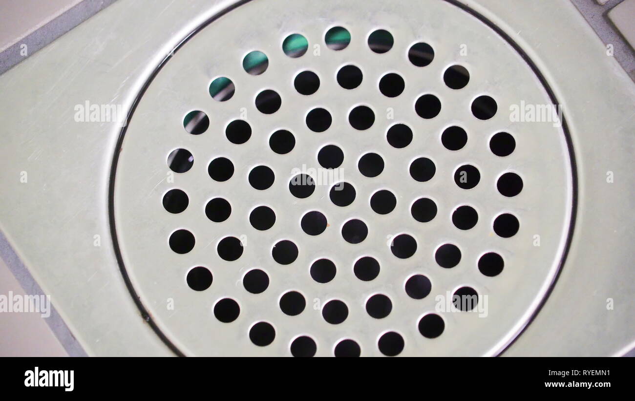 Closer look of the holes on the floor in the bathroom where water ...