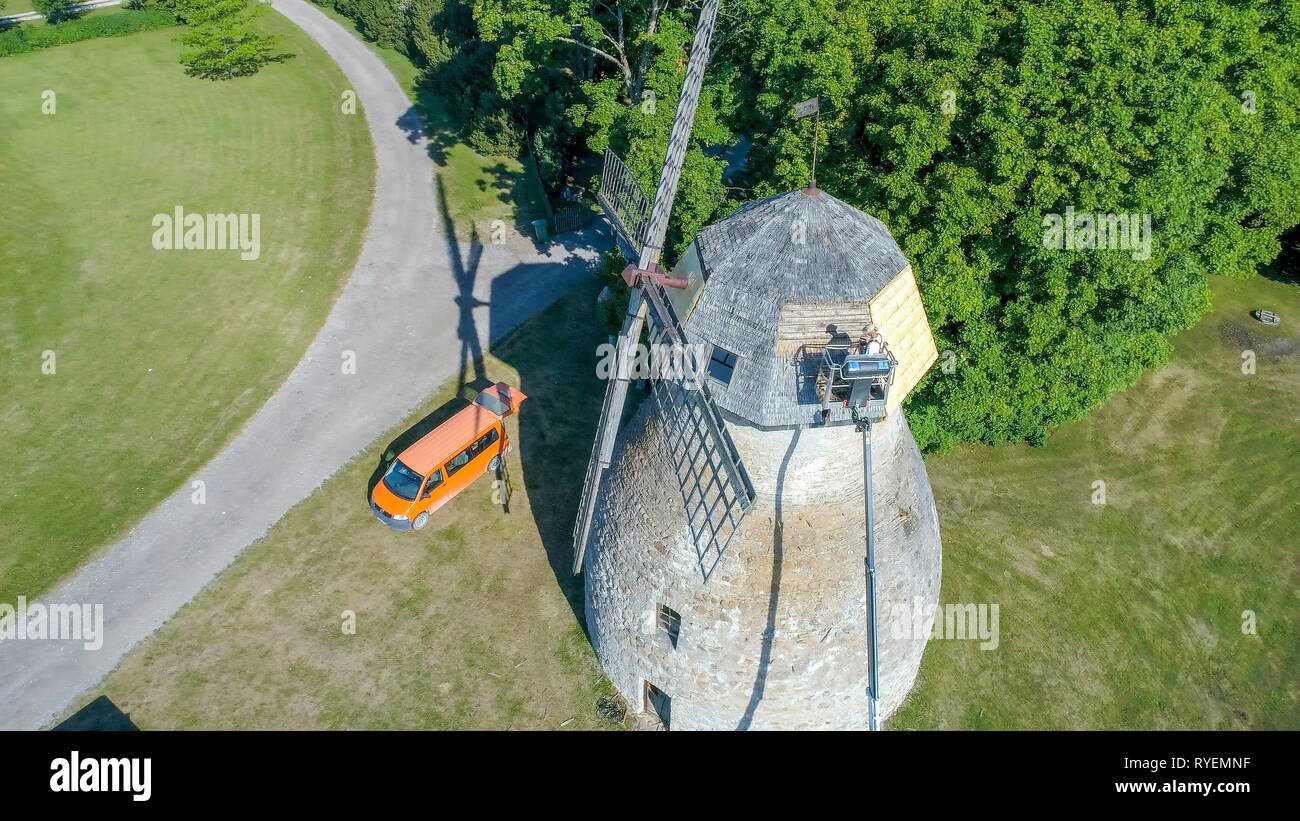The big windmill in the middle of the lawn in the forest with the ...