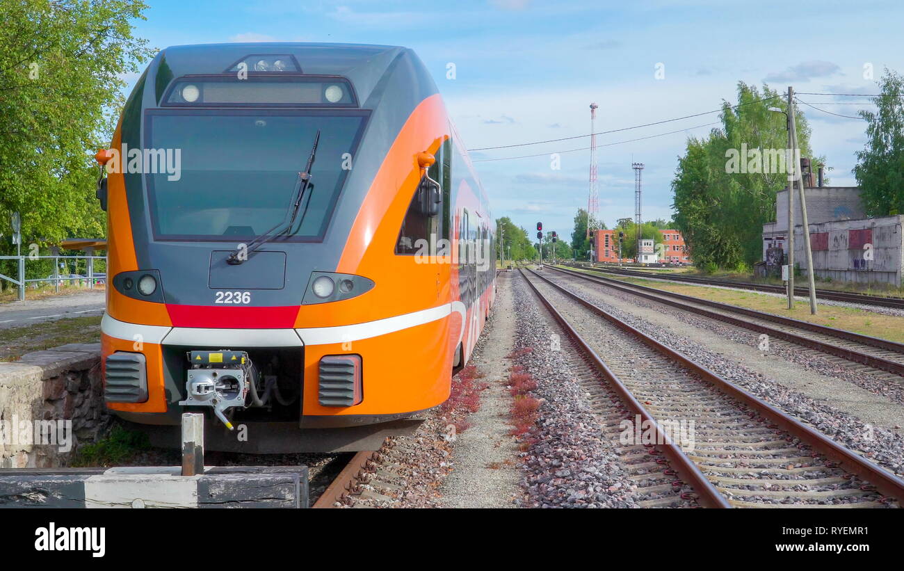 The front view of the orange color train in the station waiting for the ...