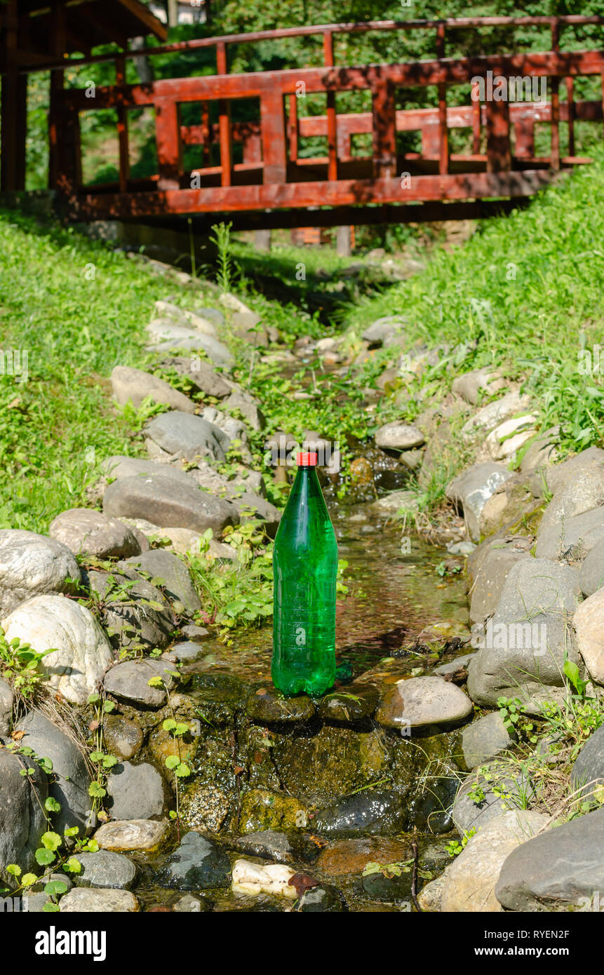 Green plastic bottle of mineral water in a stream Stock Photo - Alamy
