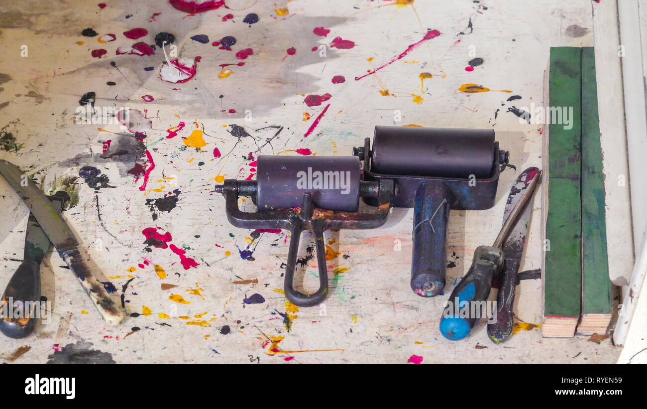 Rollers and other tools on the floor with inks all over inside the old ...