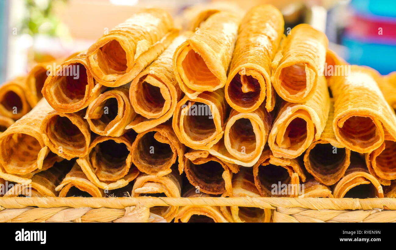 The rolled wafer waffles on the table being displayed on the food stall ...