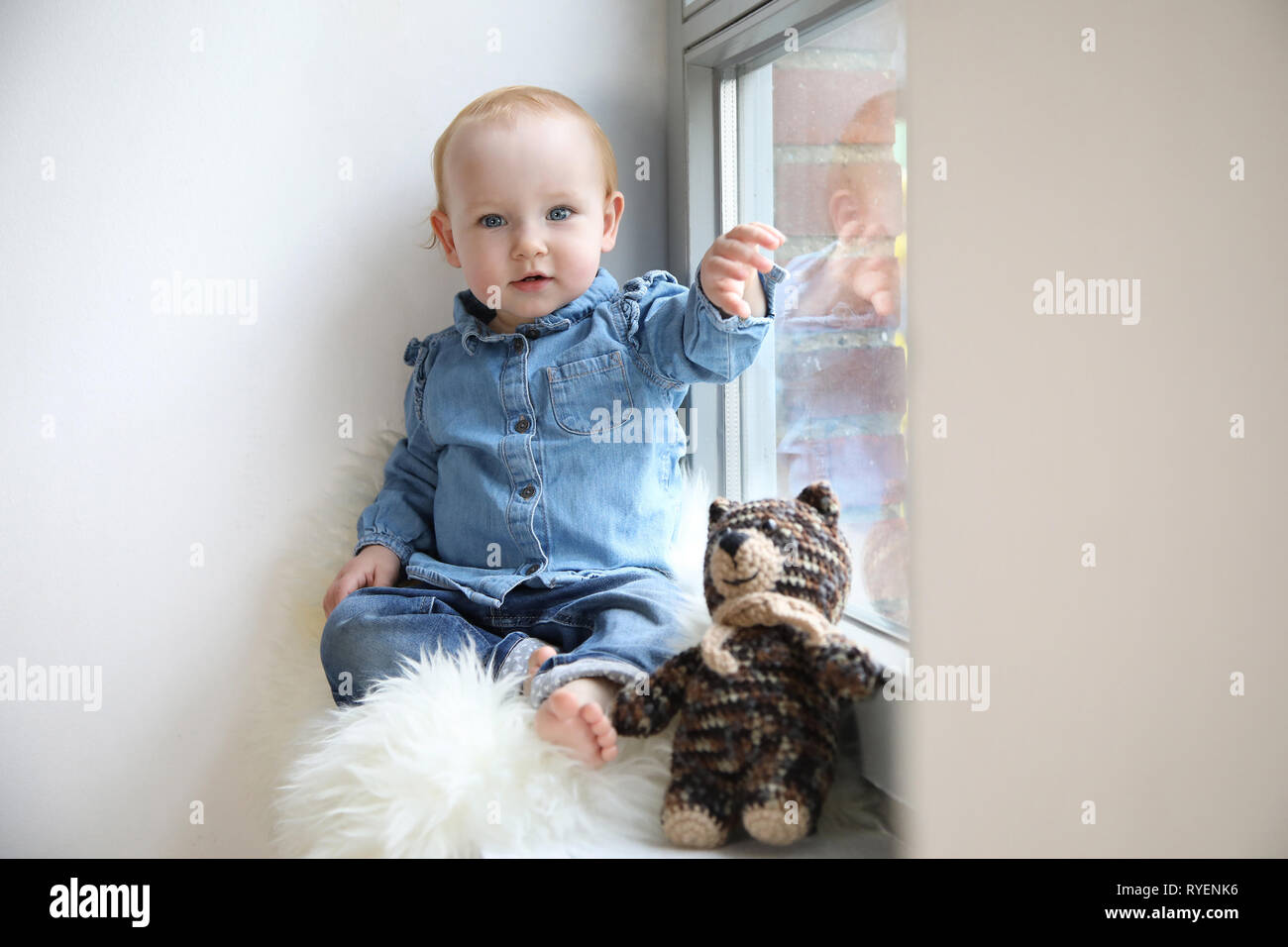Pretty child sits on window chill Stock Photo - Alamy